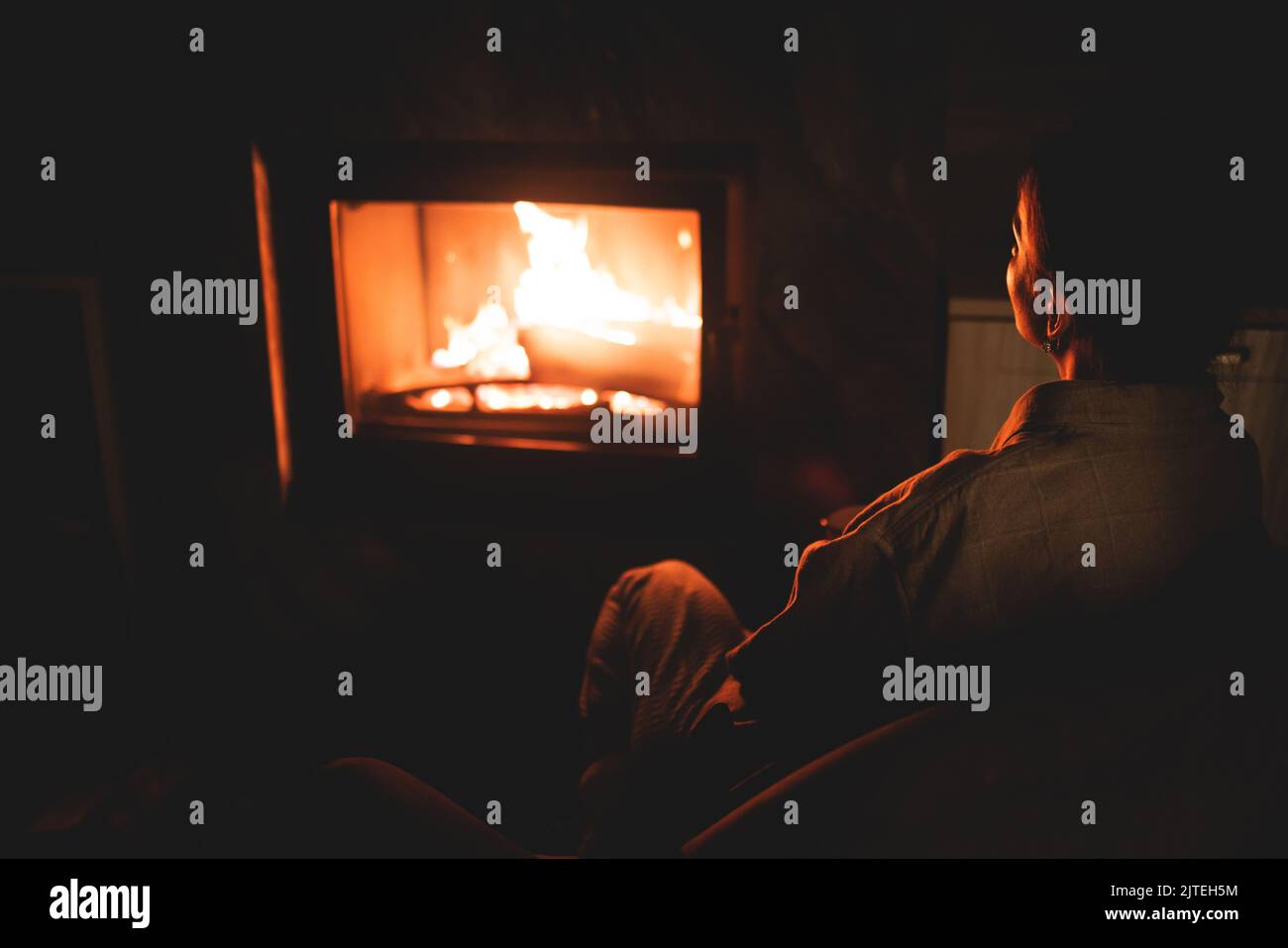 Cozy night in the cabin by the fireplace, fireplace burns in the ...