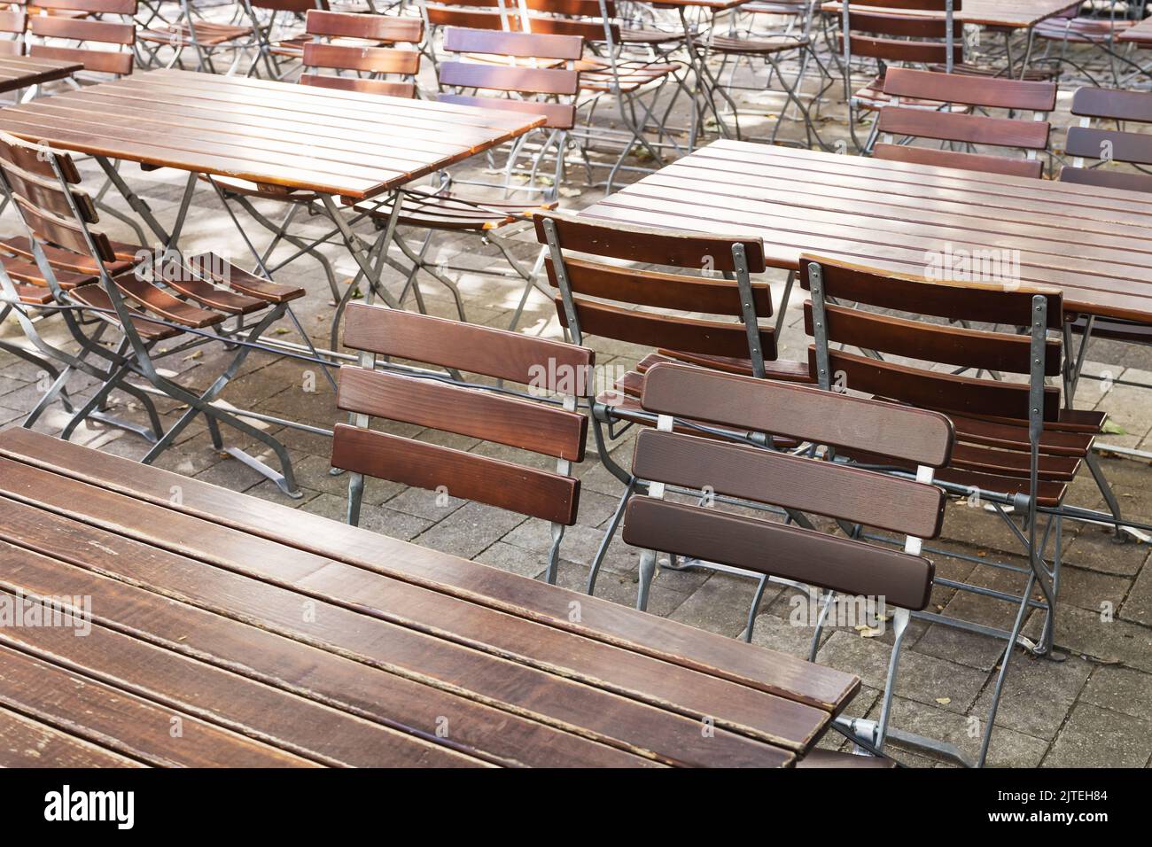 empty tables and chairs of an outdoor restaurant Stock Photo - Alamy