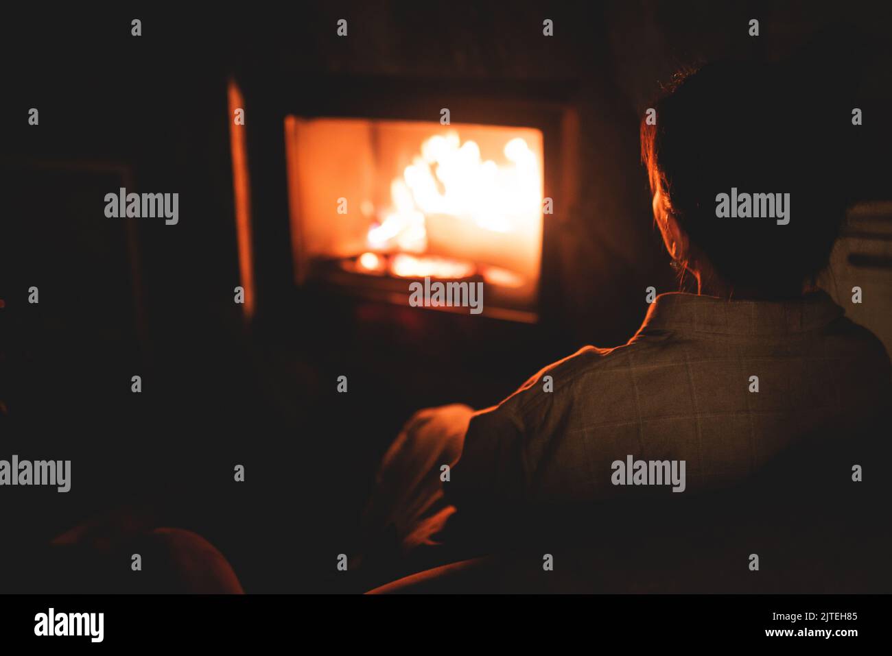 Cozy night in the cabin by the fireplace, fireplace burns in the ...