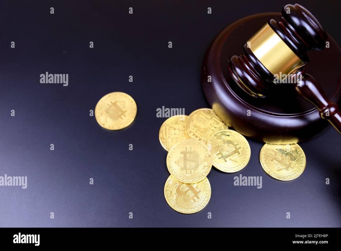 Bitcoin Gold coins and judge gavel on black background Stock Photo - Alamy