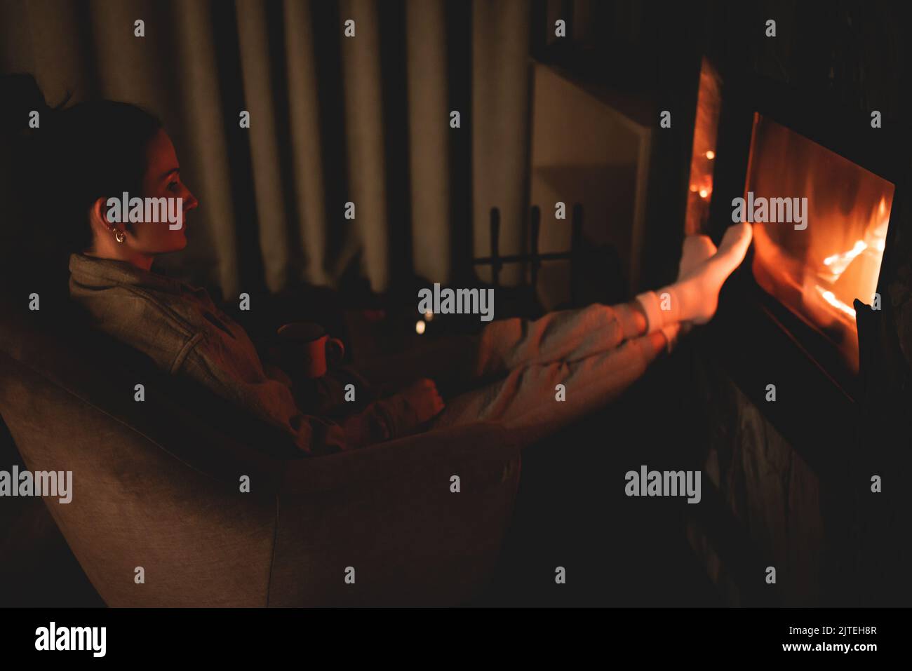 Cozy night in the cabin by the fireplace, fireplace burns in the ...