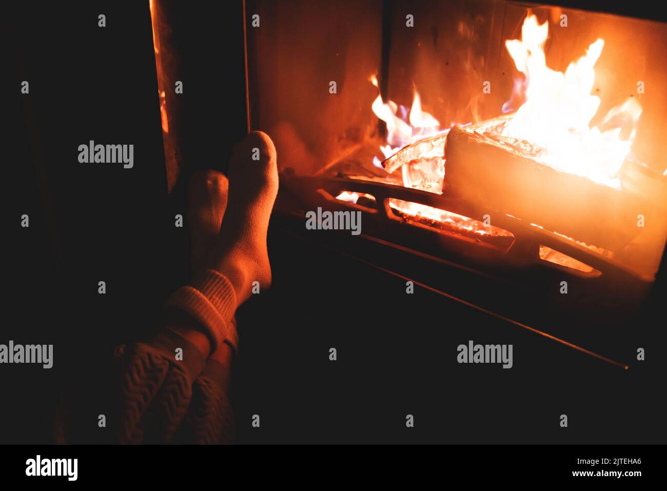 Cozy night in the cabin by the fireplace, fireplace burns in the ...