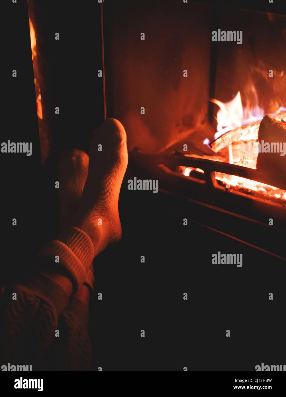 Cozy night in the cabin by the fireplace, fireplace burns in the ...