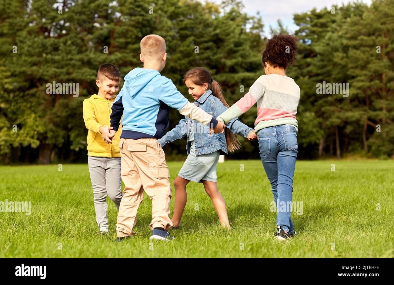happy children playing round dance at park Stock Photo - Alamy
