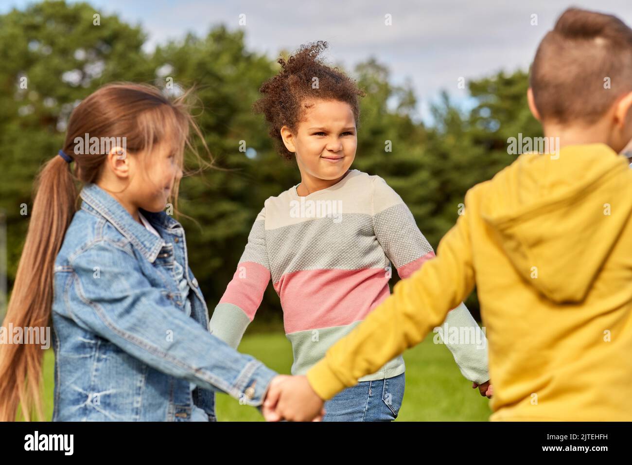 happy children playing round dance at park Stock Photo - Alamy