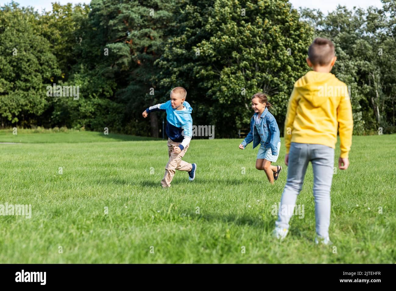 happy children playing and running at park Stock Photo - Alamy
