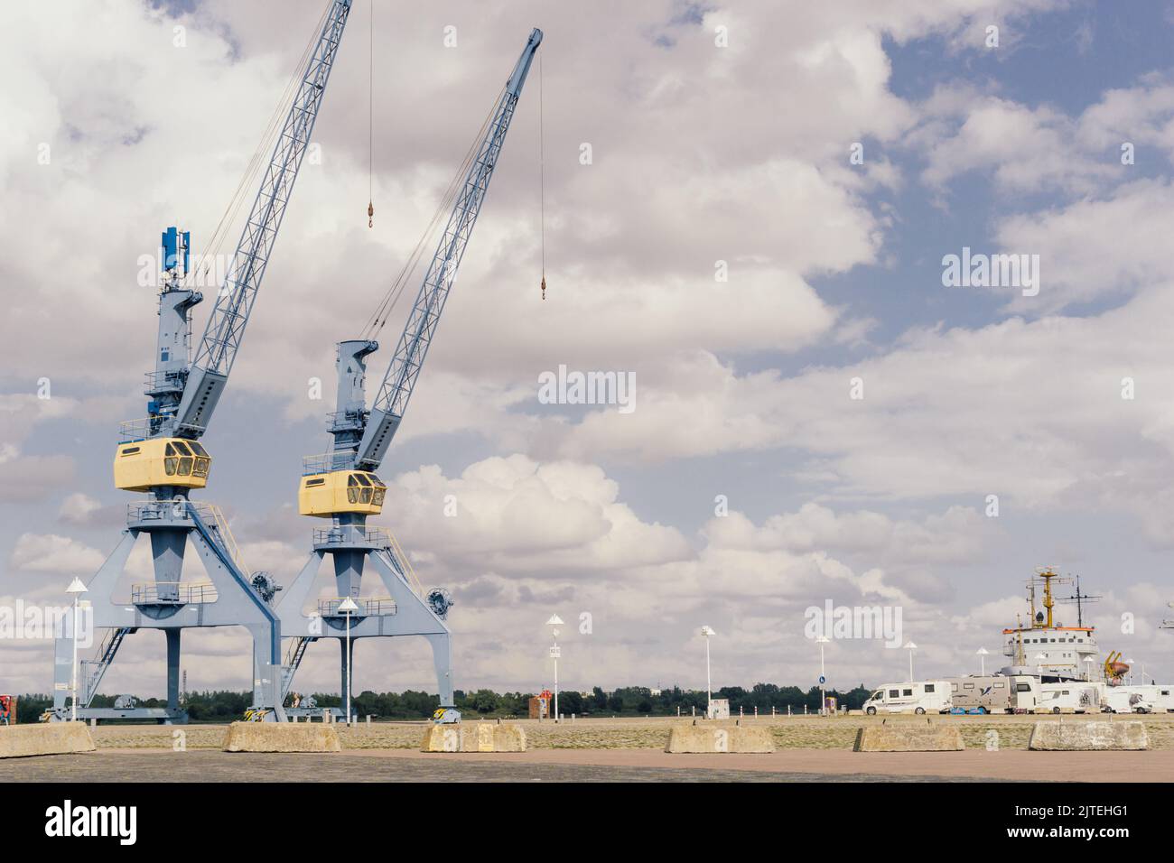 Cranes and caravans in the port area Stock Photo - Alamy