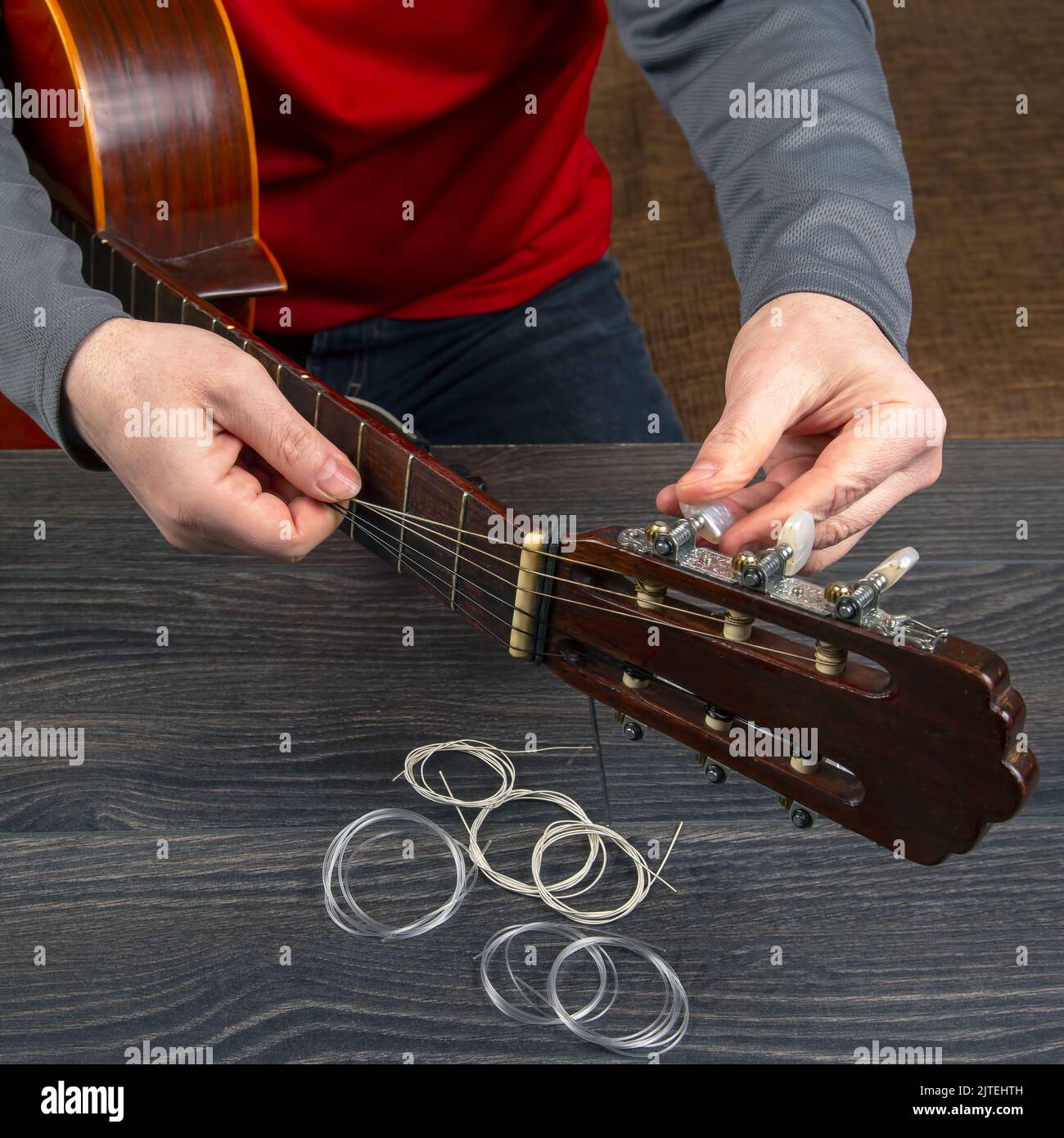 replacement and insertion of nylon strings in a classical guitar ...