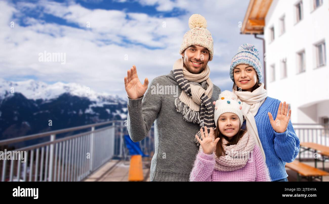 happy family waving hands over mountains and hotel Stock Photo - Alamy