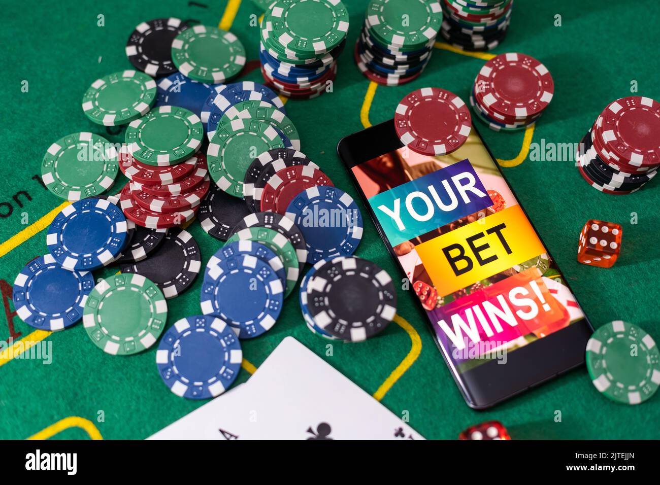 Online poker concept. Smartphone and poker chips on a green background ...