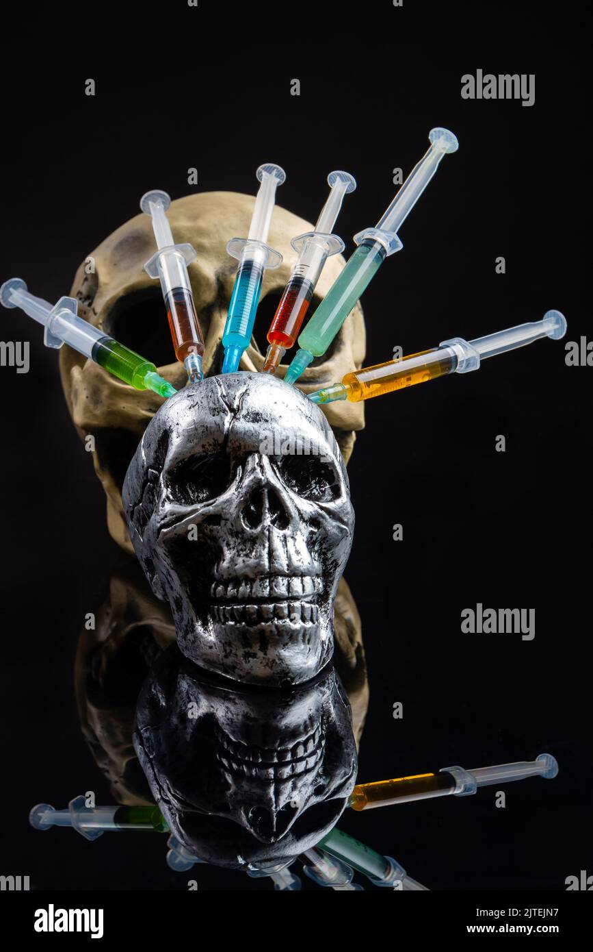 Death and drug overdose concept. Humans skulls on black background ...