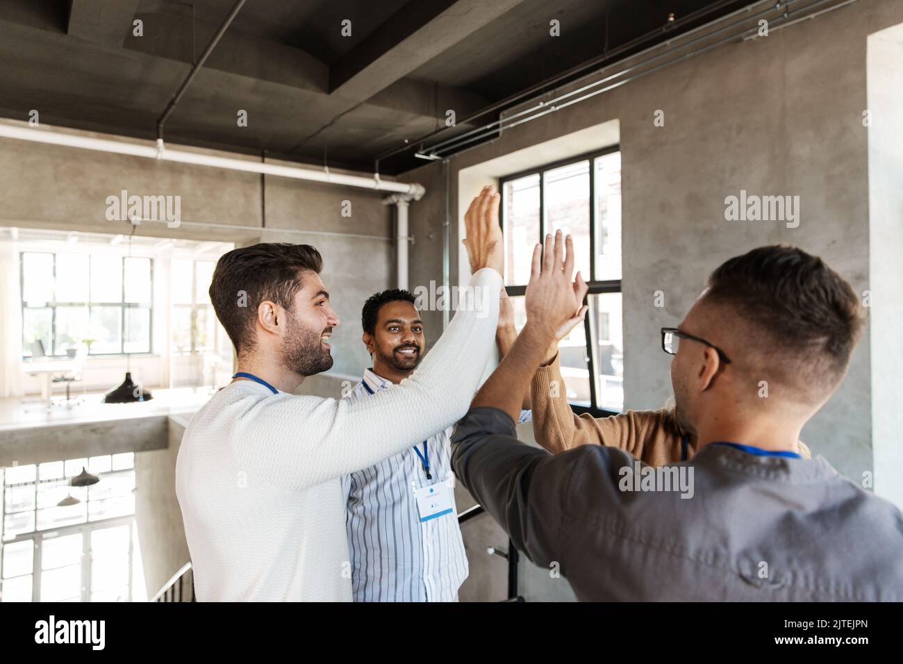 business people making high five gesture at office Stock Photo - Alamy