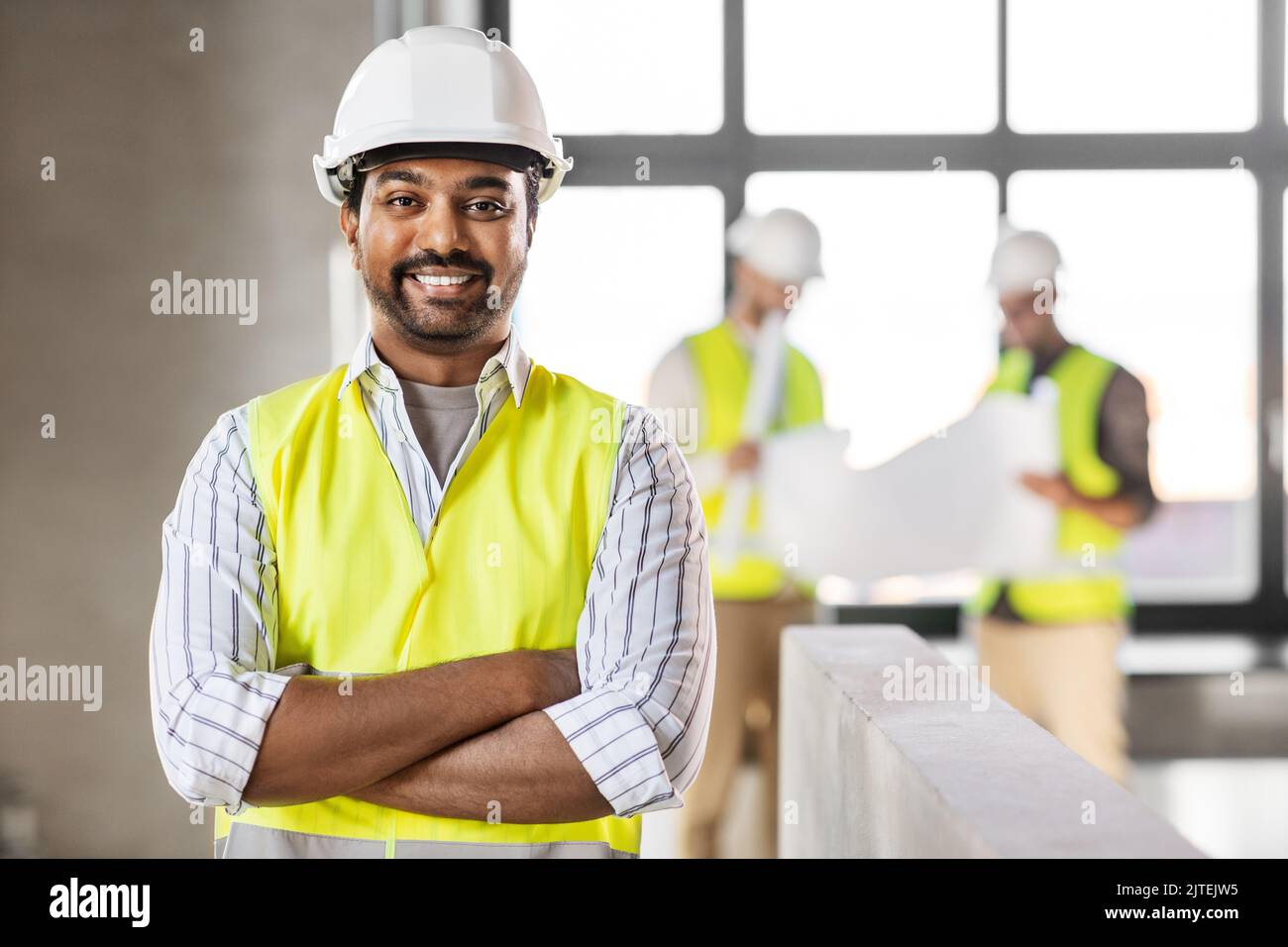 male architect in helmet and safety west at office Stock Photo - Alamy