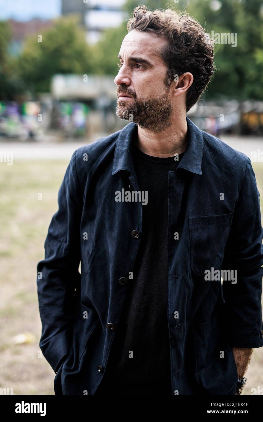 Berlin, Germany. 23rd Aug, 2022. Actor Oliver Wnuk stands on a lawn ...