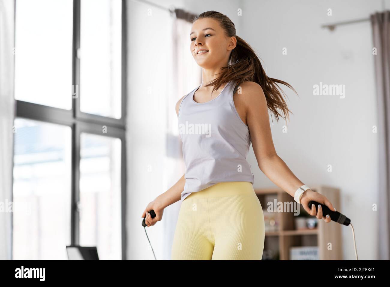 teenage girl exercising with jump rope at home Stock Photo - Alamy