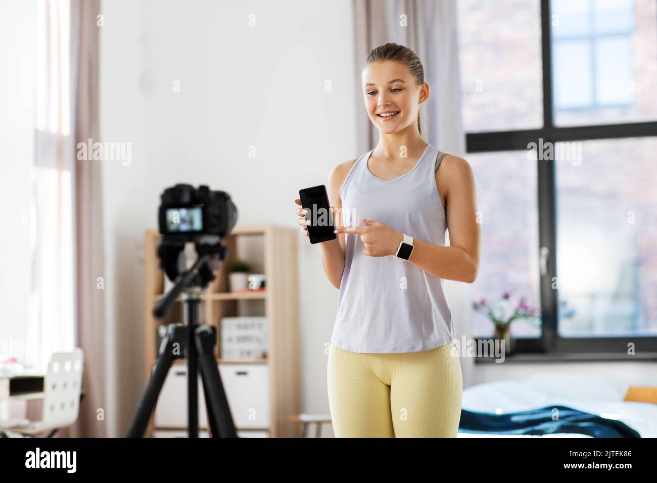 teenage girl or blogger recording gym class video Stock Photo - Alamy