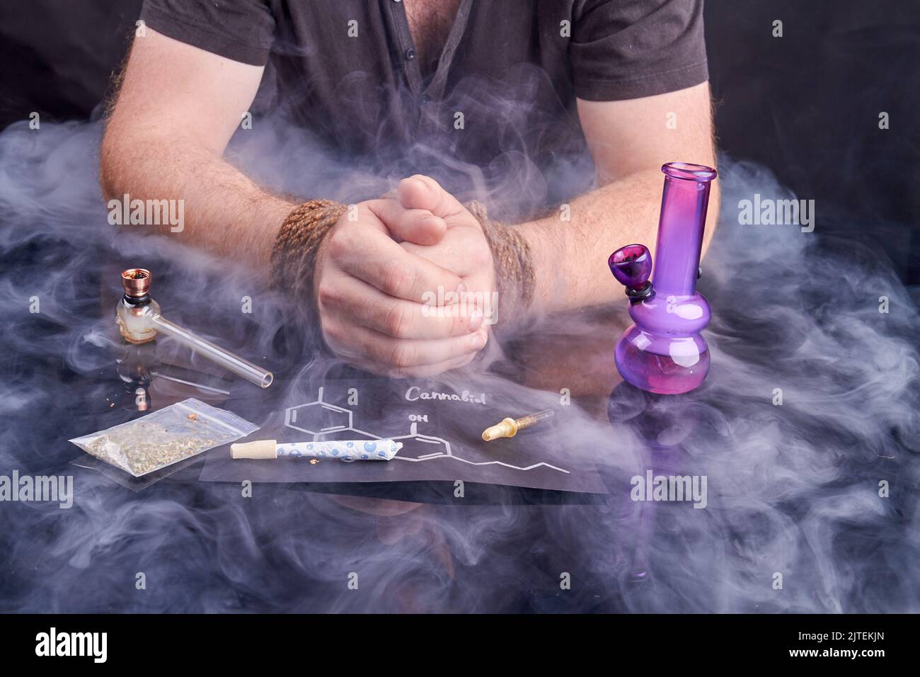 Hostage of cannabis. Drug addiction slavery concept. Bound male hands ...