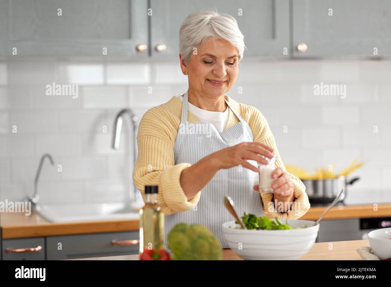 happy woman cooking salad on kitchen at home Stock Photo - Alamy