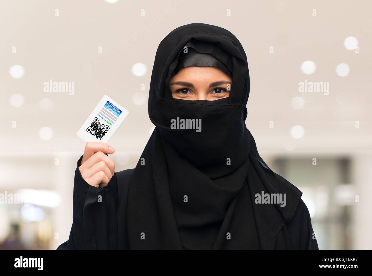 woman in hijab with immunity passport qr code Stock Photo - Alamy