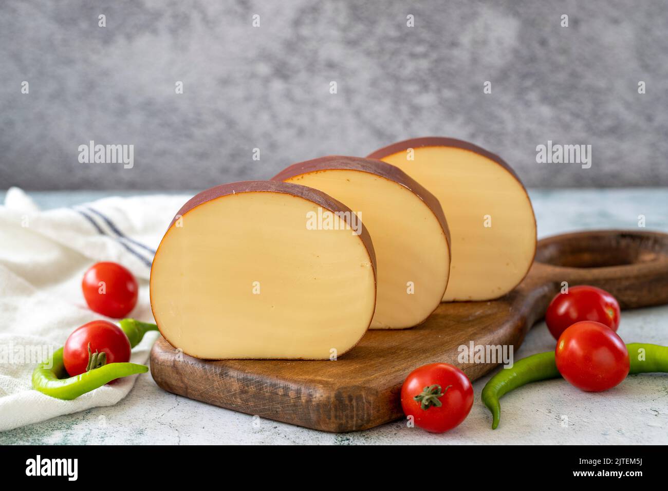 Smoked cheese. Dutch smoked cheese on stone background. close up Stock ...