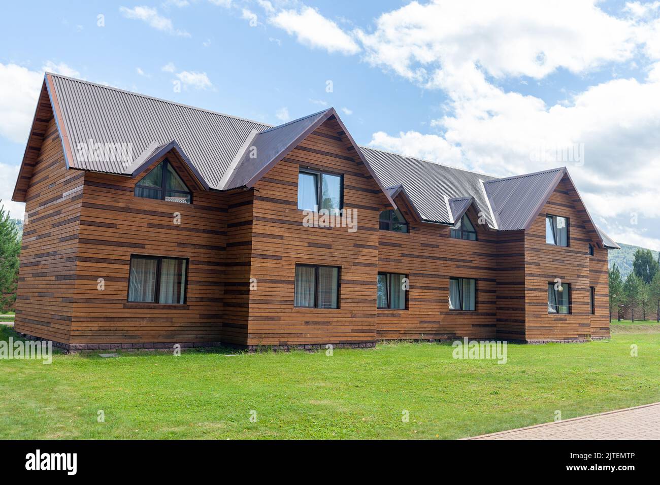 Two-storey wooden cottage with windows nature with a green lawn. Sale ...