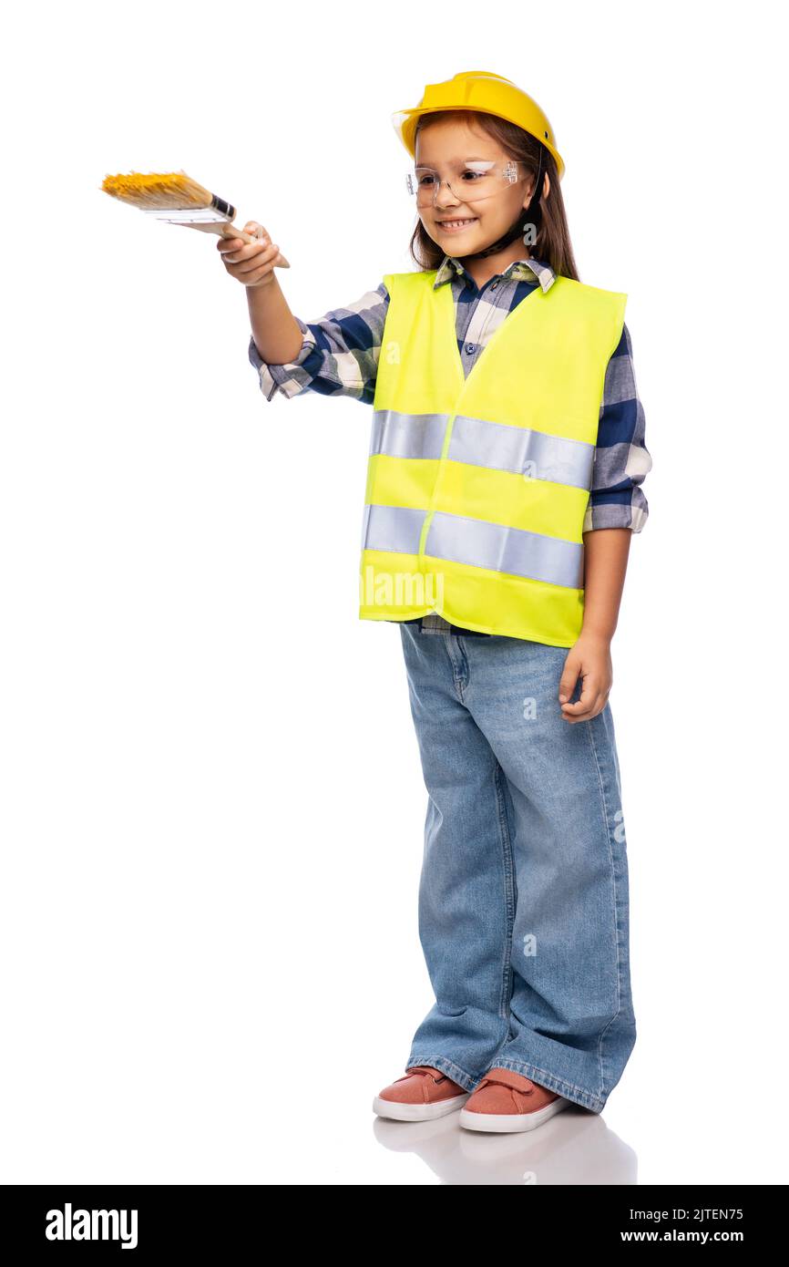 girl in helmet and safety vest with paint brush Stock Photo - Alamy
