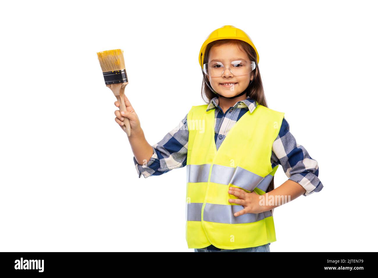 girl in helmet and safety vest with paint brush Stock Photo - Alamy