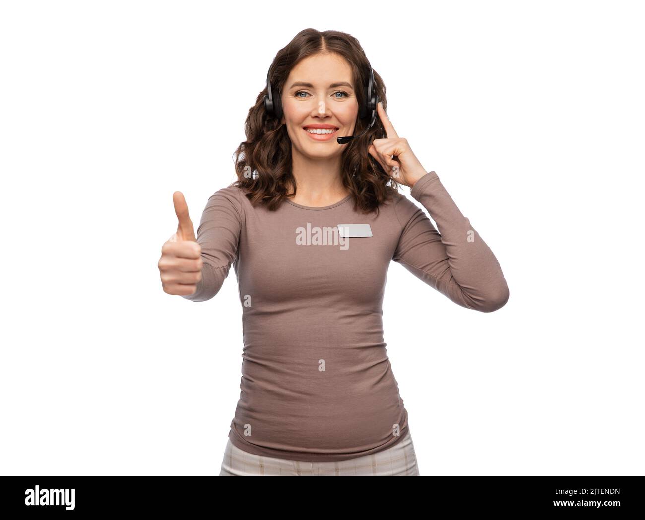 shop assistant with headset showing thumbs up Stock Photo - Alamy
