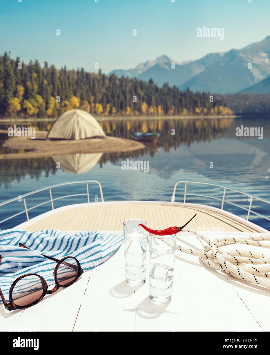 Summer river trip. Two shots of vodka with hot pepper on deck of ...