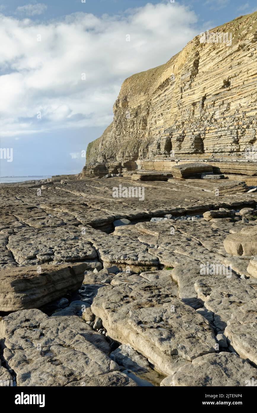 Wave cut, limestone pavement and layered cliffs of limestone and ...