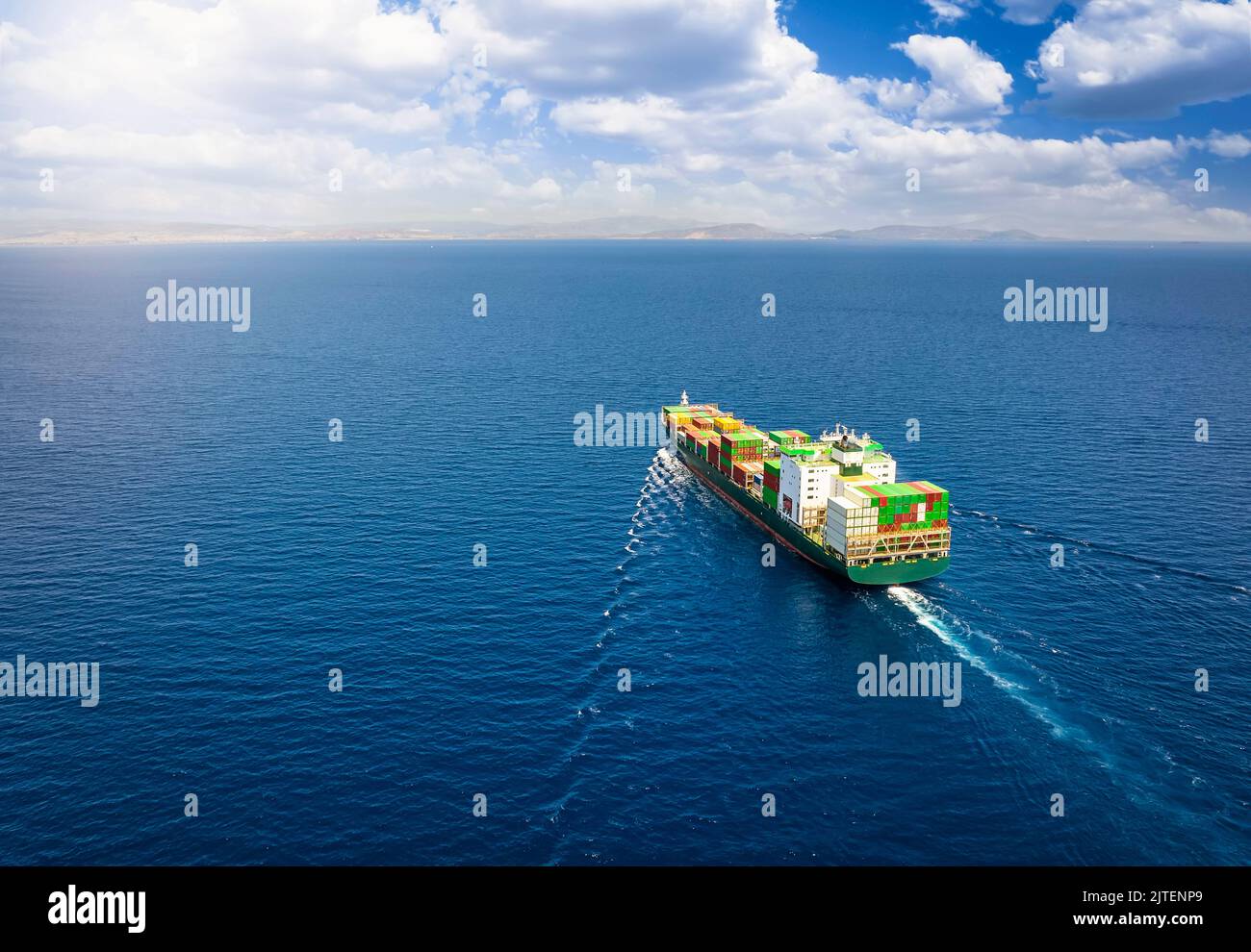 A large cargo container ship traveling over the open ocean Stock Photo ...