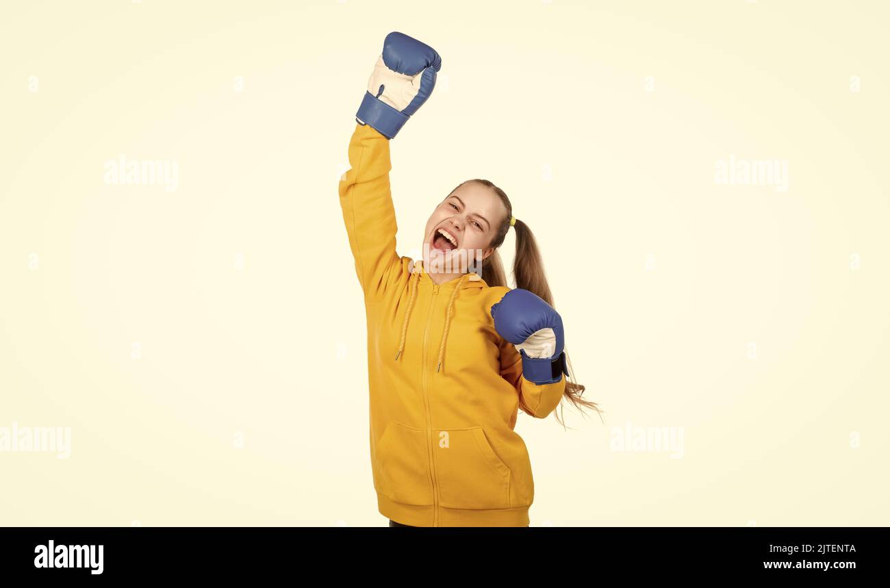 happy teen girl boxer in boxing gloves celebrating victory in fight ...