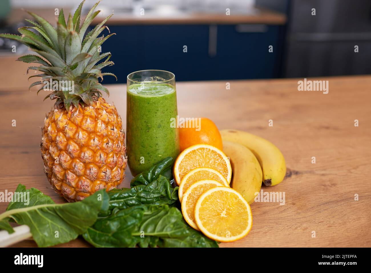 Still life of fruit and freshly made green smoothie on kitchen ...