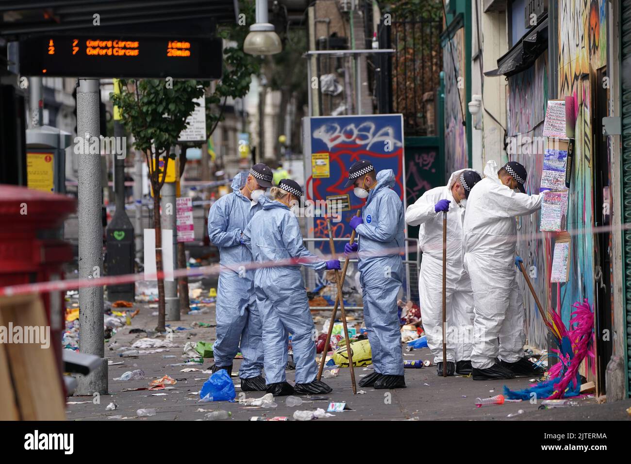 Forensics officers comb the scene in Ladbroke Grove, west London, where ...