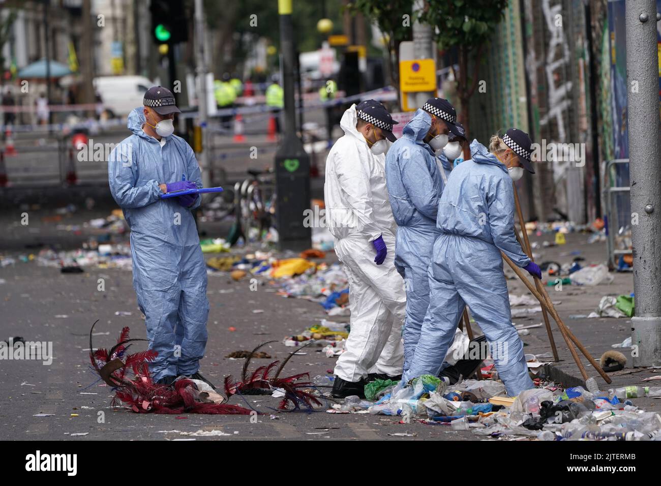 Forensics officers comb the scene in Ladbroke Grove, west London, where ...