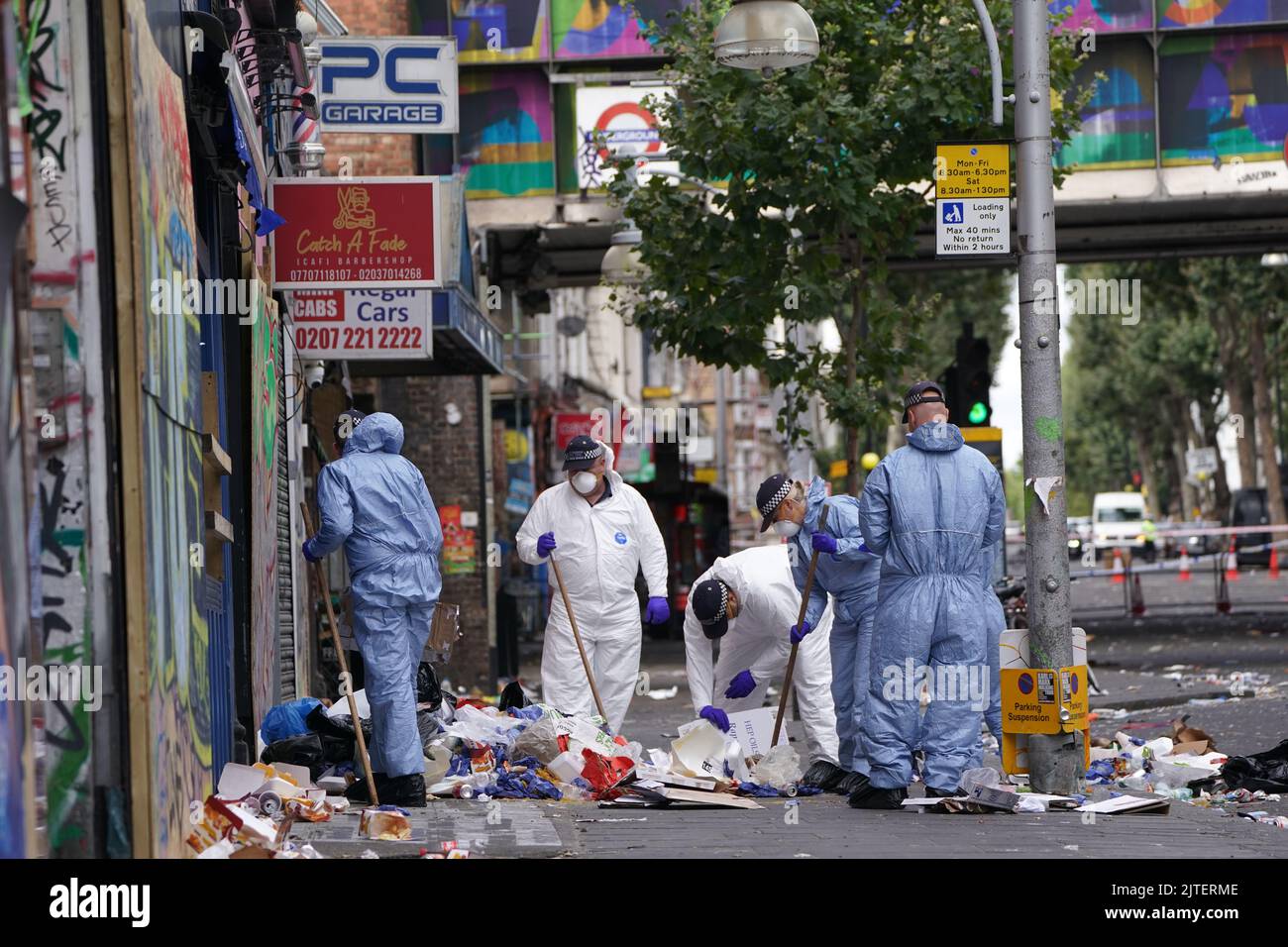 Forensics officers comb the scene in Ladbroke Grove, west London, where ...