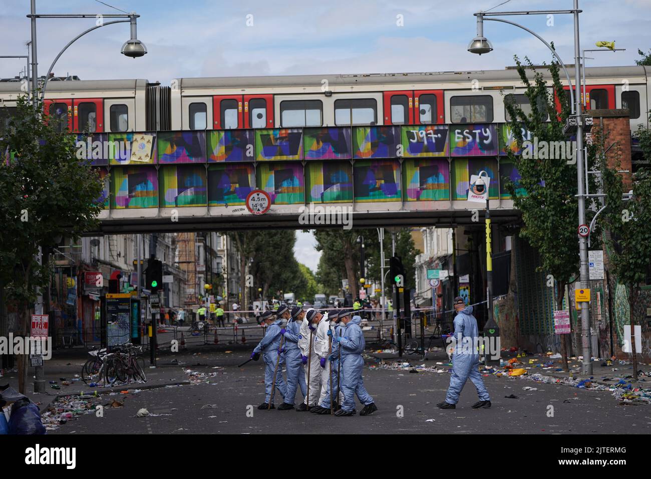 Forensics officers comb the scene in Ladbroke Grove, west London, where ...