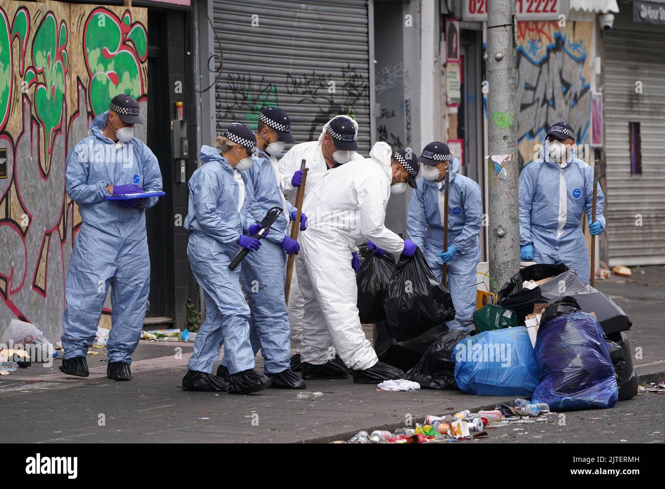 Forensics officers comb the scene in Ladbroke Grove, west London, where ...