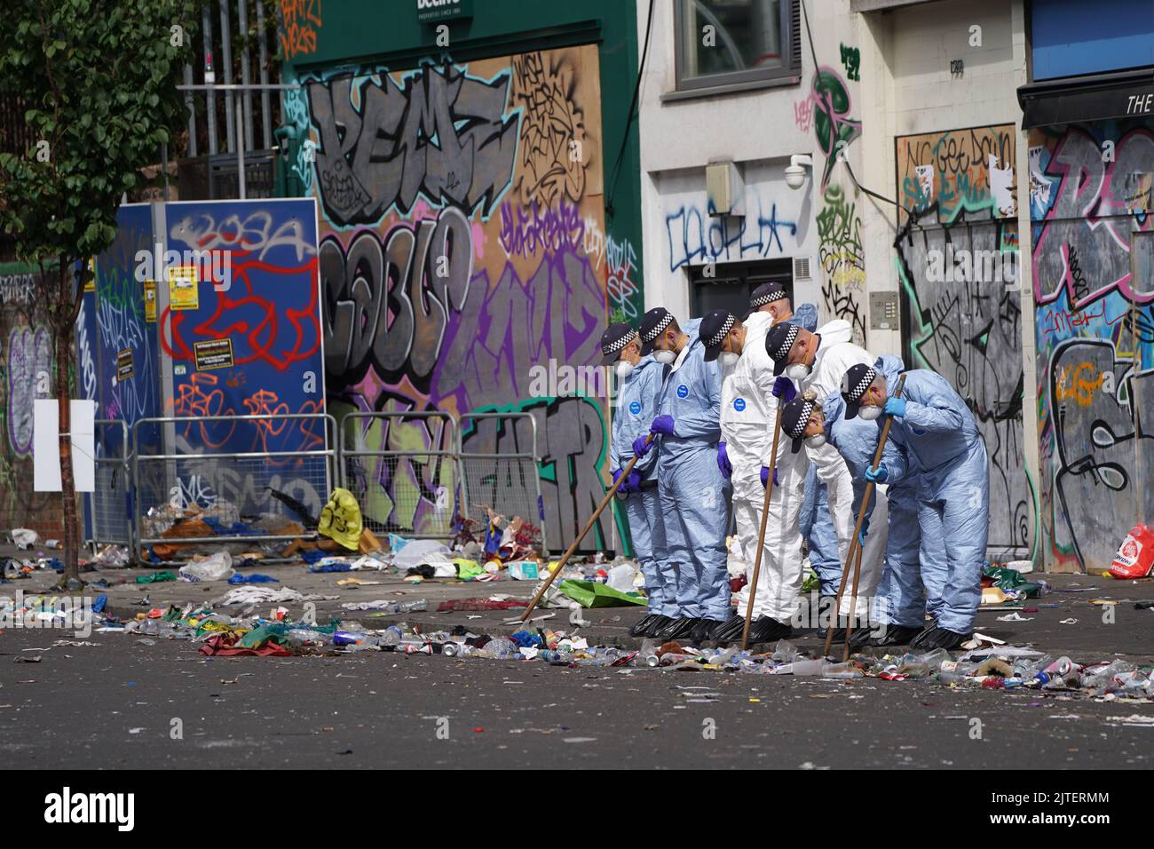 Forensics officers comb the scene in Ladbroke Grove, west London, where ...