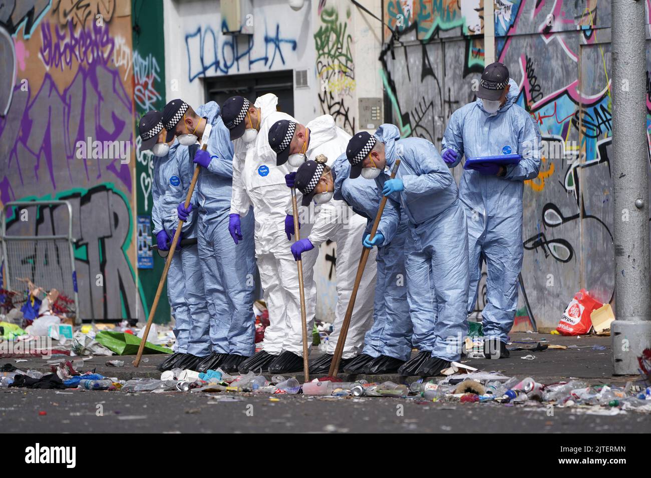 Forensics officers comb the scene in Ladbroke Grove, west London, where ...
