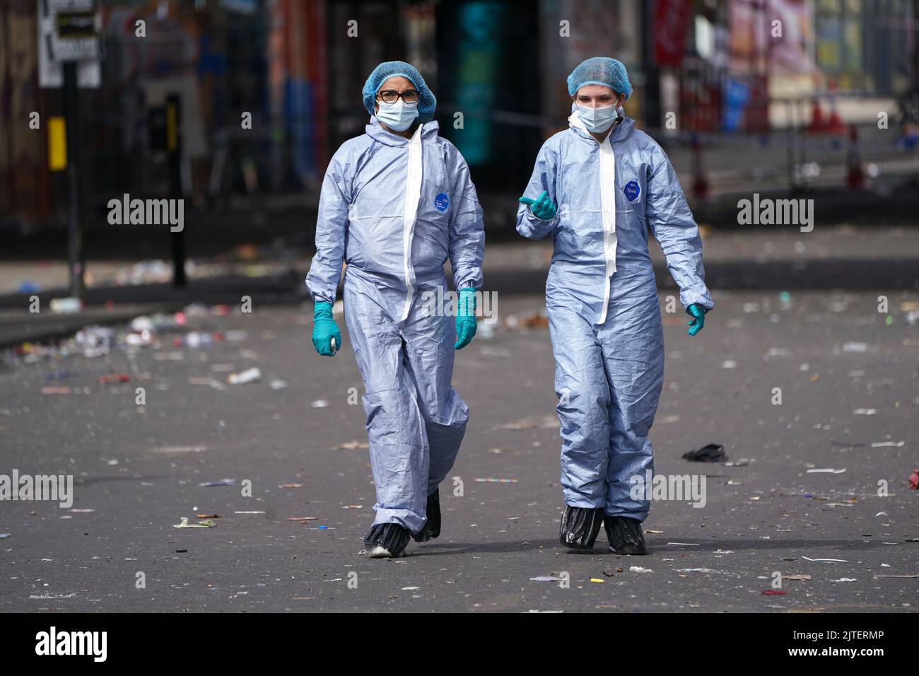 Forensics officers comb the scene in Ladbroke Grove, west London, where ...