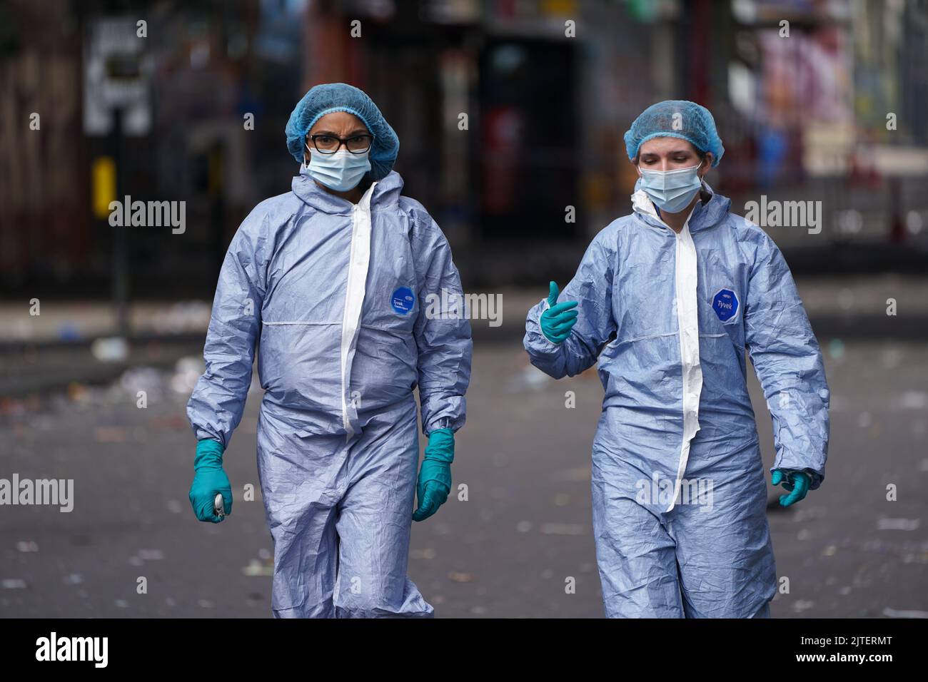 Forensics officers comb the scene in Ladbroke Grove, west London, where ...