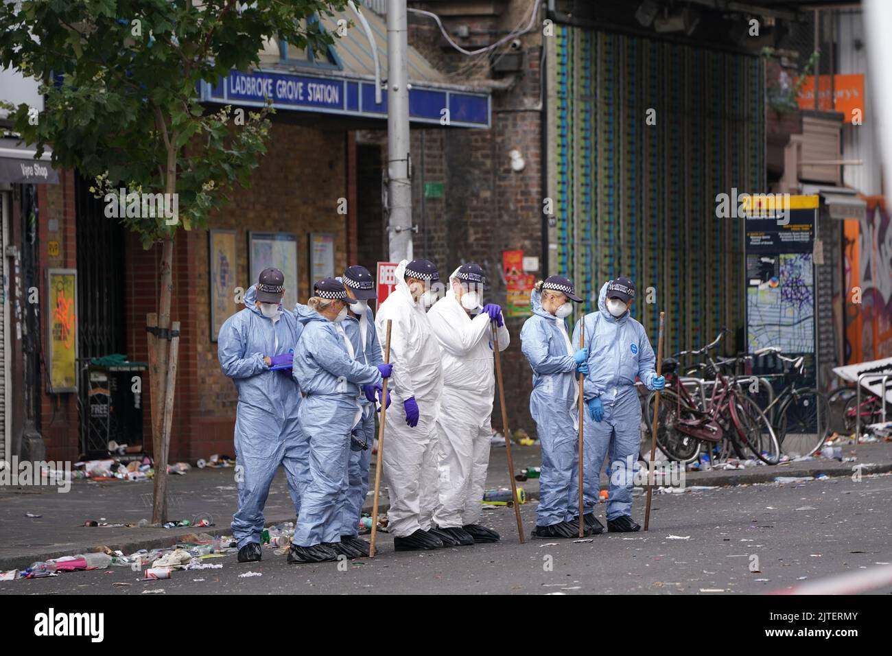 Forensics officers comb the scene in Ladbroke Grove, west London, where ...