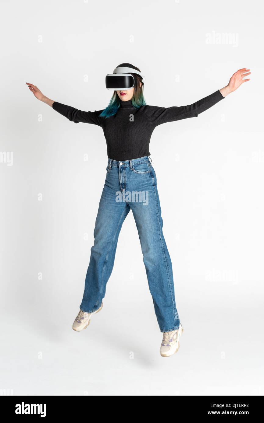 Virtual reality. A teenage girl with blue hair wearing virtual reality ...