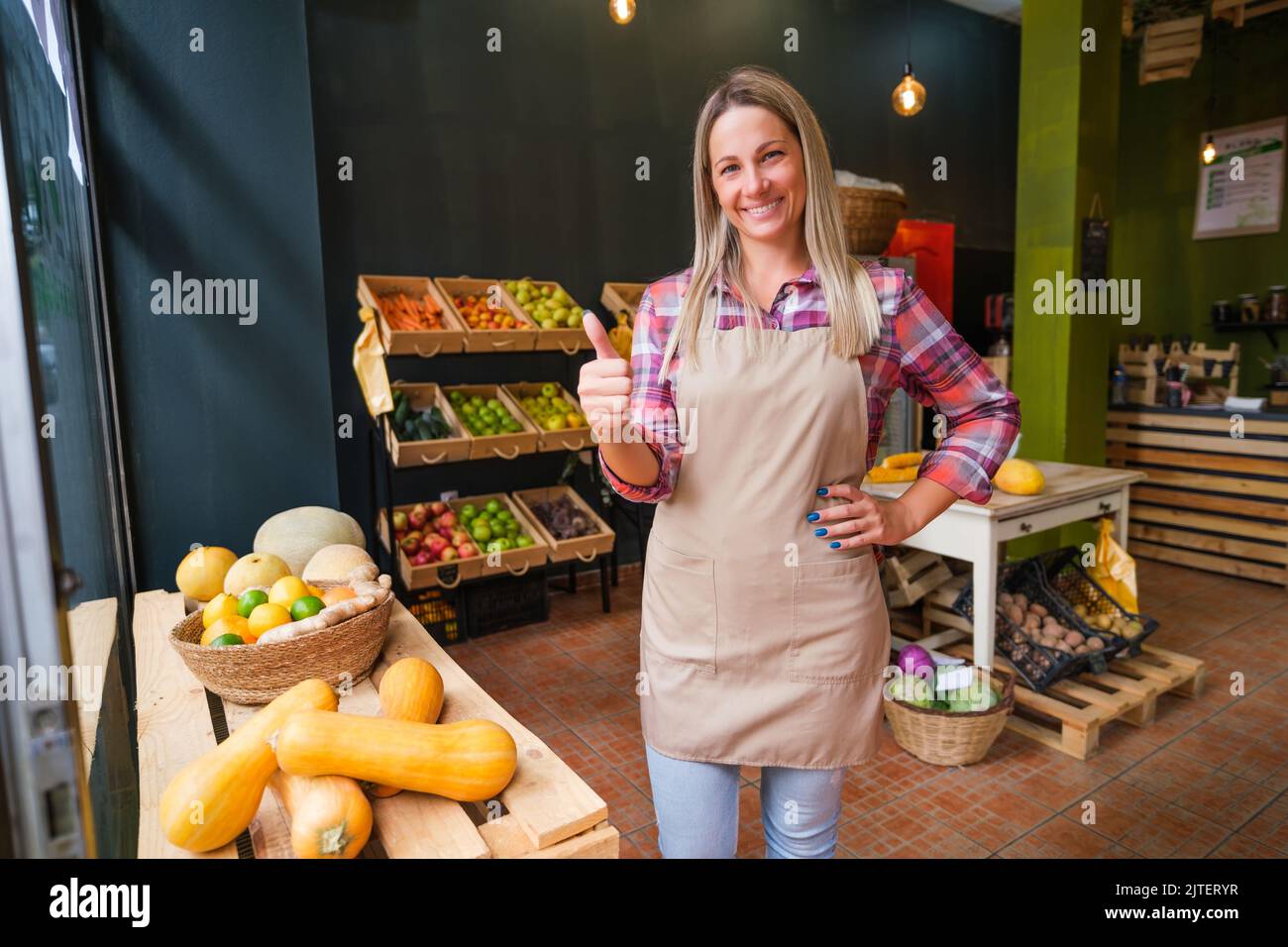 Portrait of happy food supermarket owner. Woman works in fruits and ...