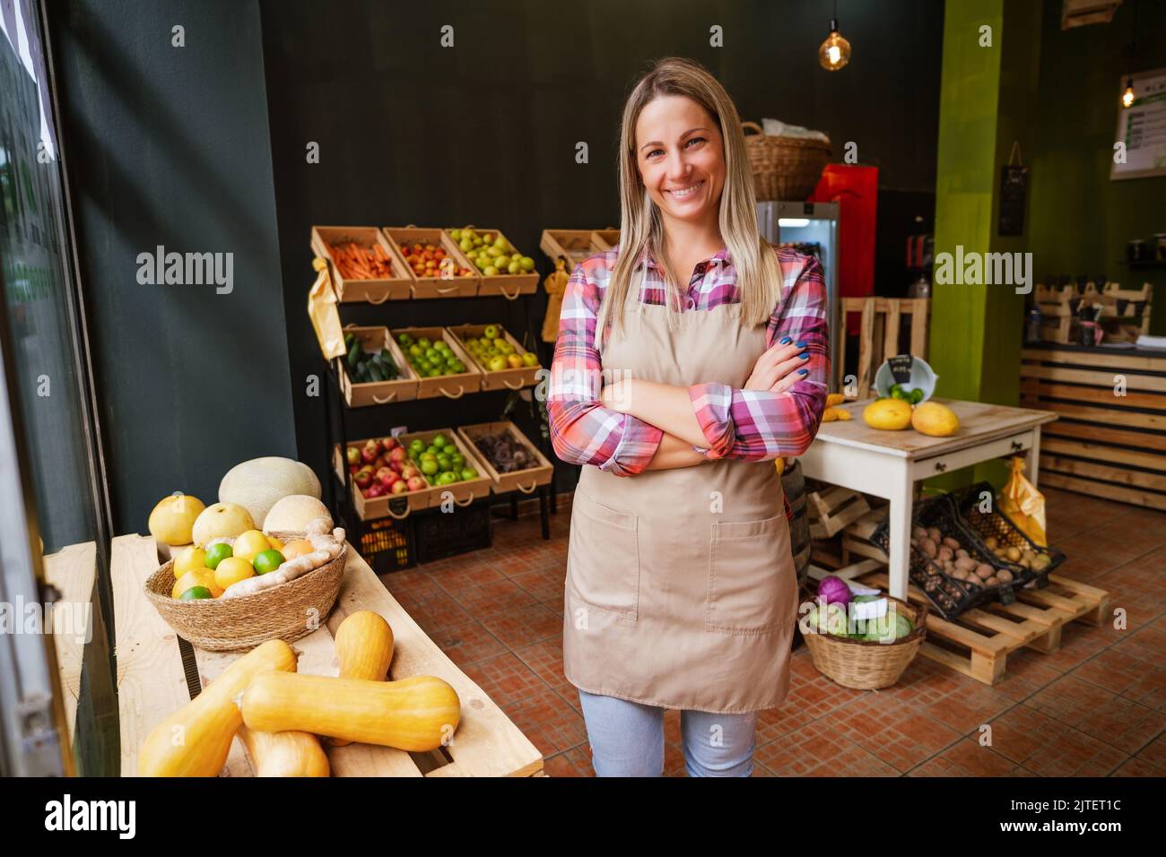 Portrait of happy food supermarket owner. Woman works in fruits and ...