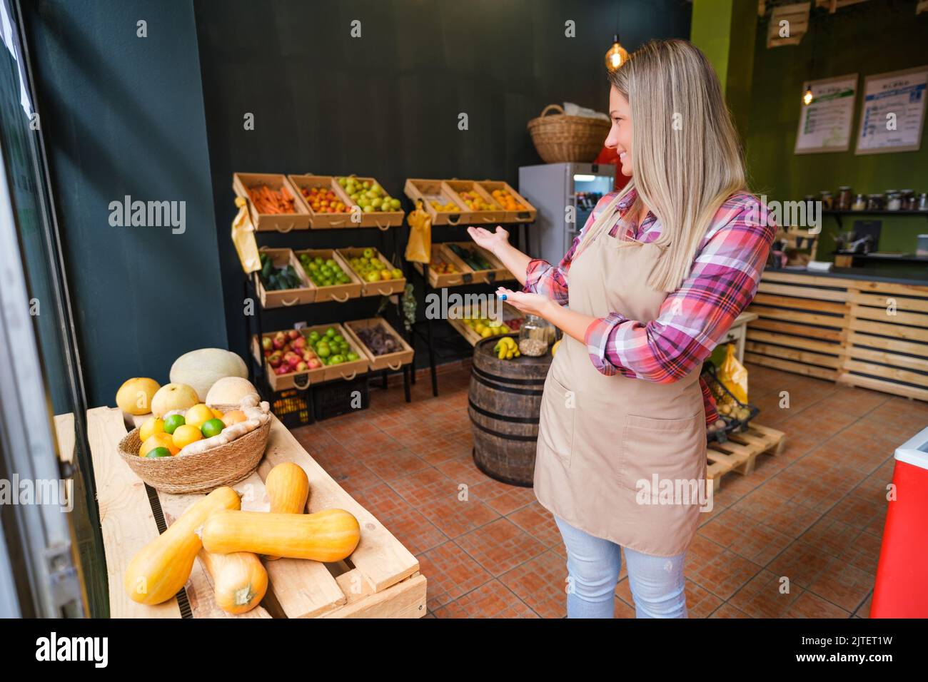 Portrait of happy food supermarket owner. Woman works in fruits and ...