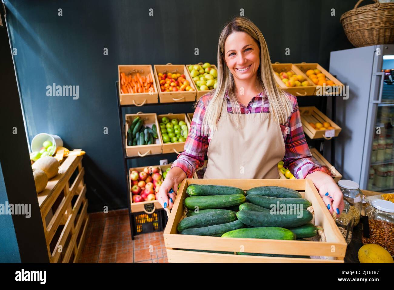 Portrait of happy food supermarket owner. Woman works in fruits and ...