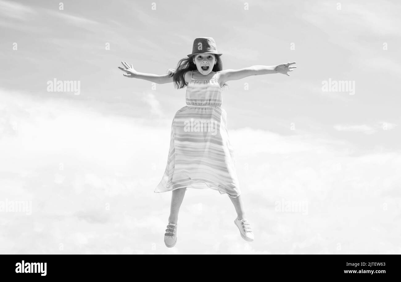 happy child jump in summer dress on sky background, freedom Stock Photo ...