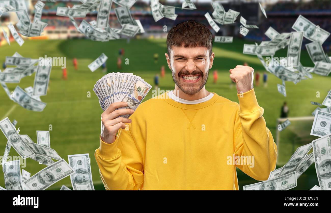 happy man with money over football field Stock Photo - Alamy